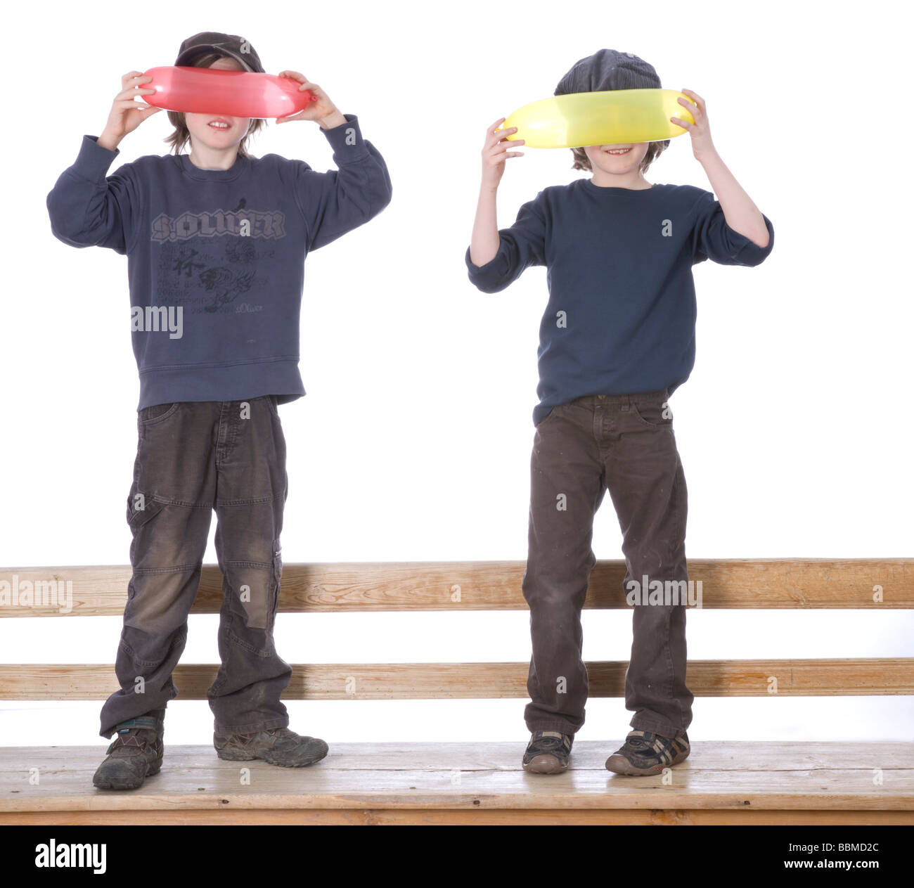 Two boys wearing caps, playing with balloons Stock Photo - Alamy