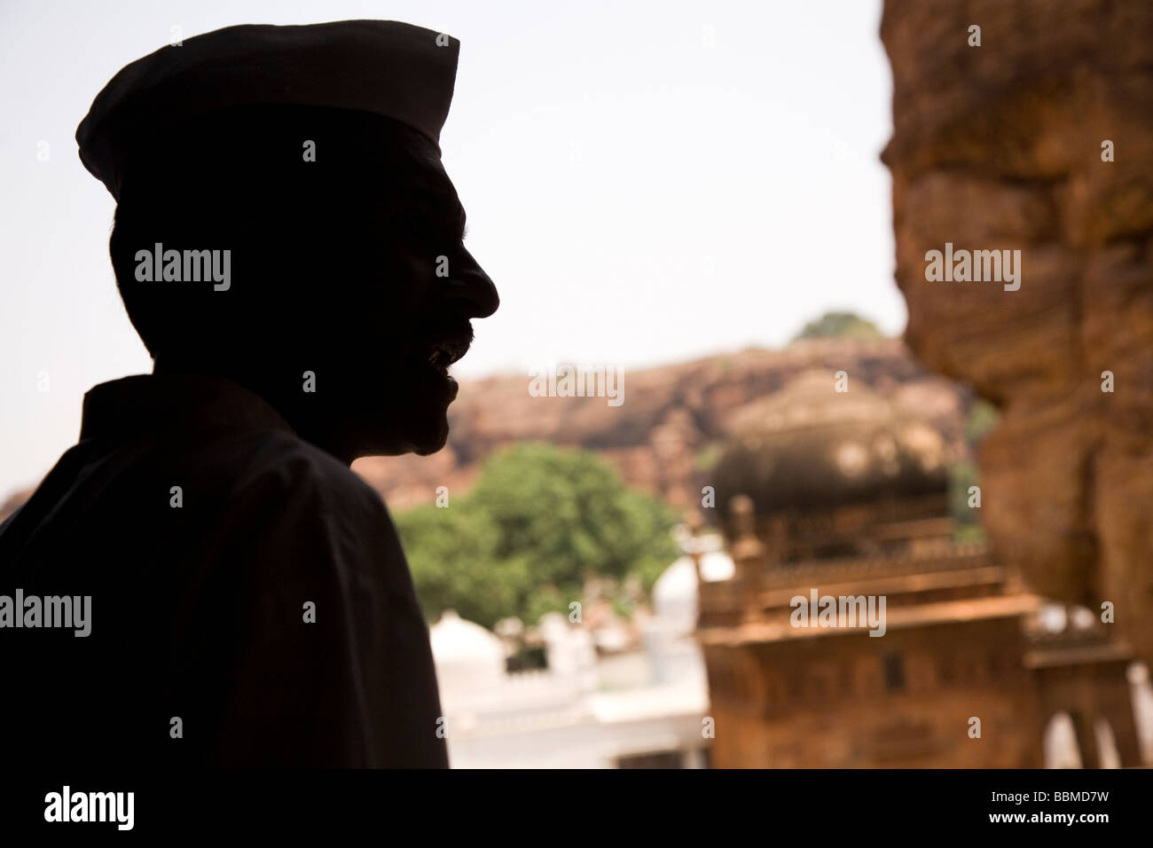 The silhouetted figure of a tour guide in traditional Karnatakan Kapi ...