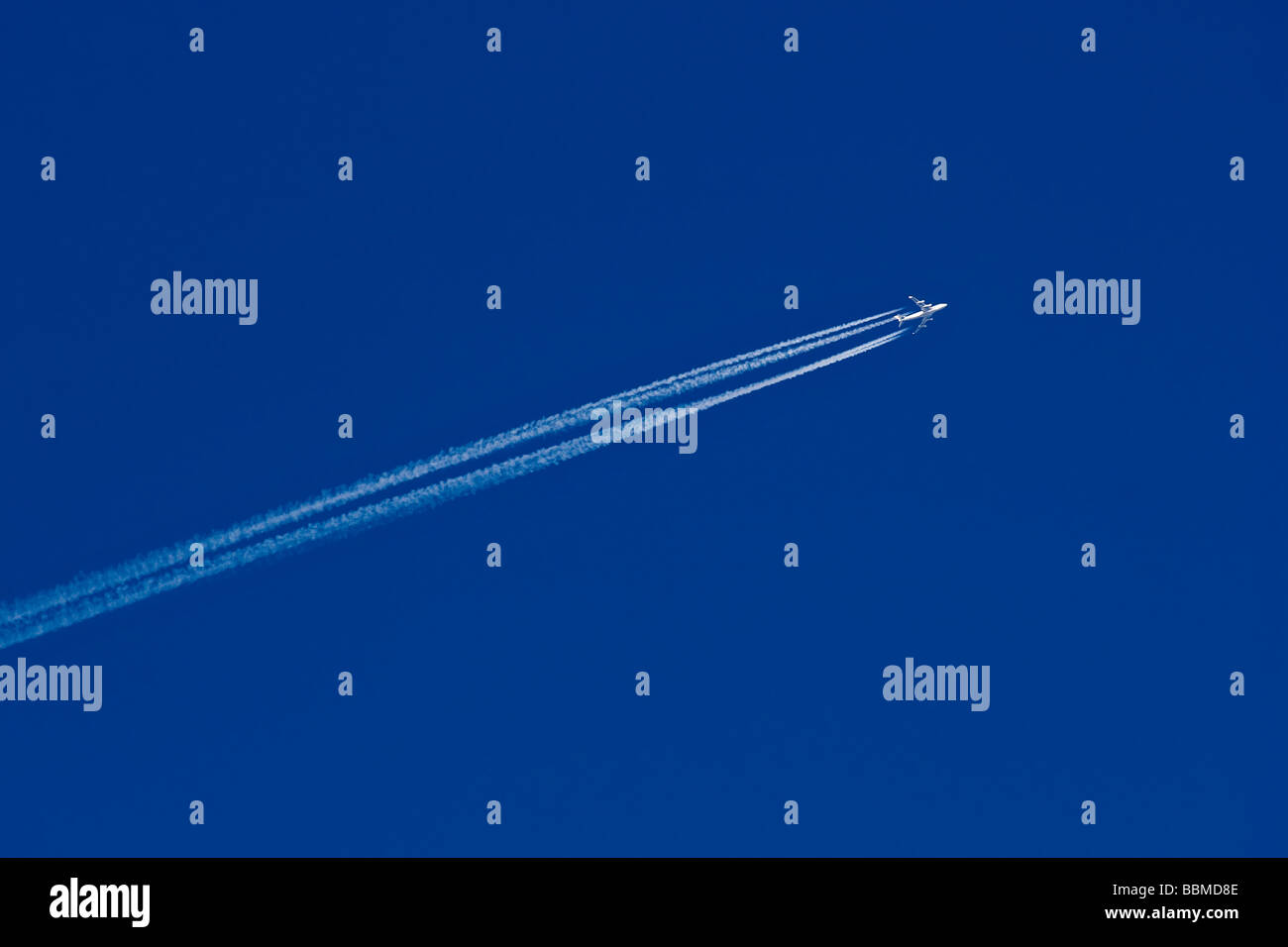 flying jet airplane on blue sky background Stock Photo - Alamy