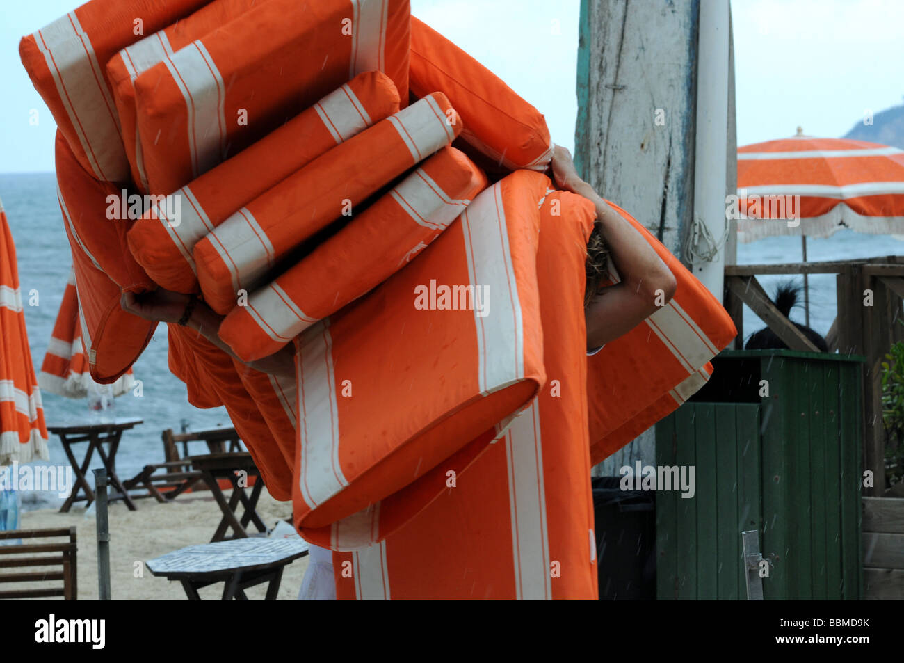 a Man carrying mats on his shoulder Stock Photo - Alamy