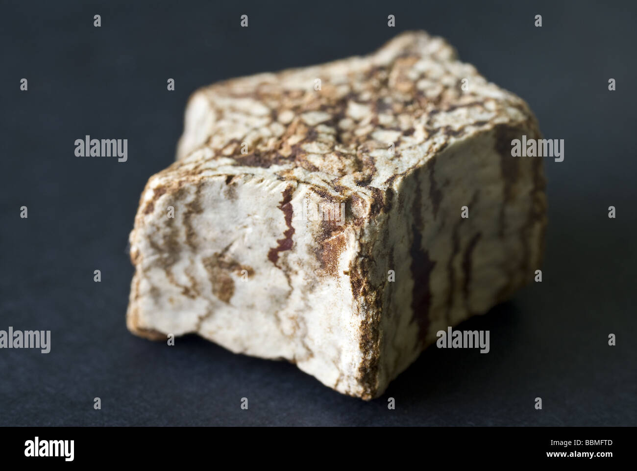 White and brown piece of decorative rock on a table Stock Photo - Alamy