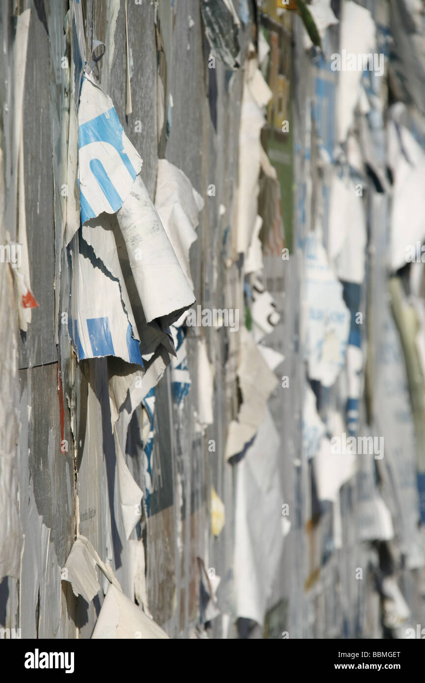 old posters adverts removed from wall in city town Stock Photo - Alamy