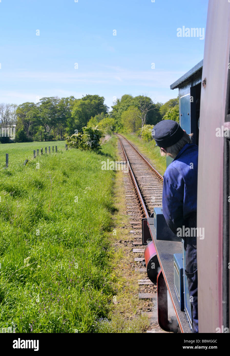 Looking out the window from a steam train as it travels on a section of ...