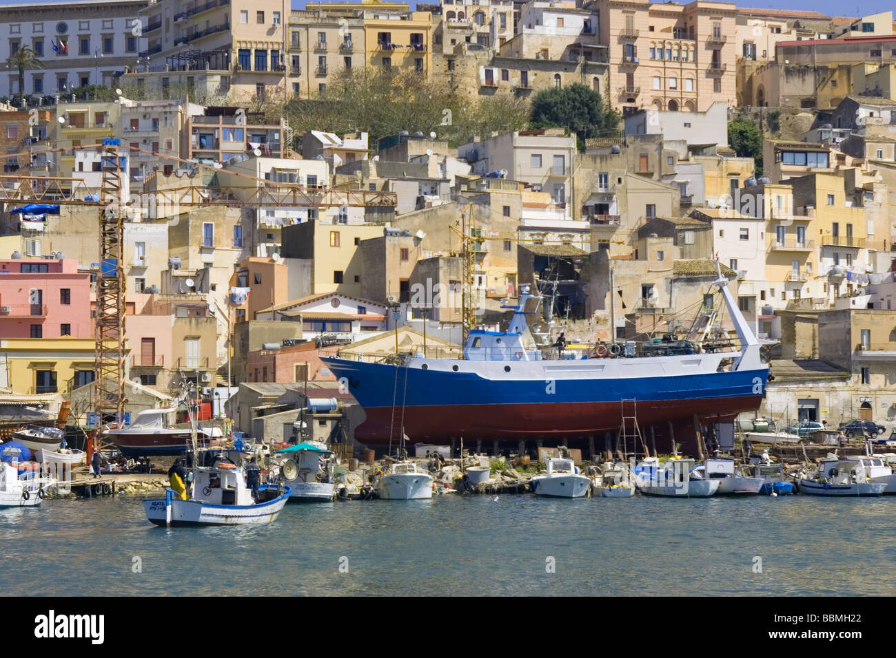 Fishing boats in harbor town in background Sciacca Sicily Italy Europe ...