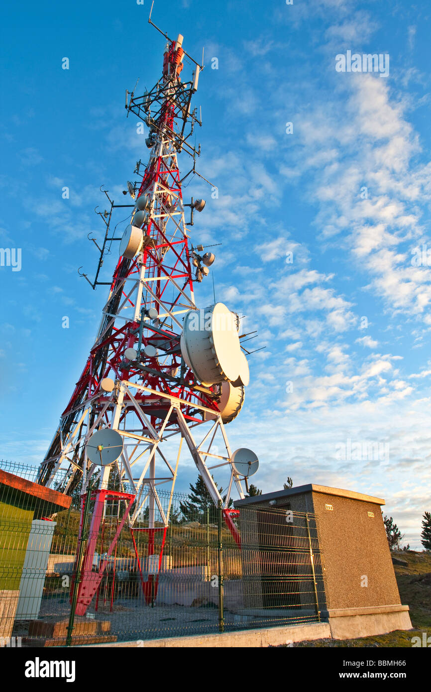 Telecommunications tower with parabolic antennas over a blue sky Stock Photo - Alamy