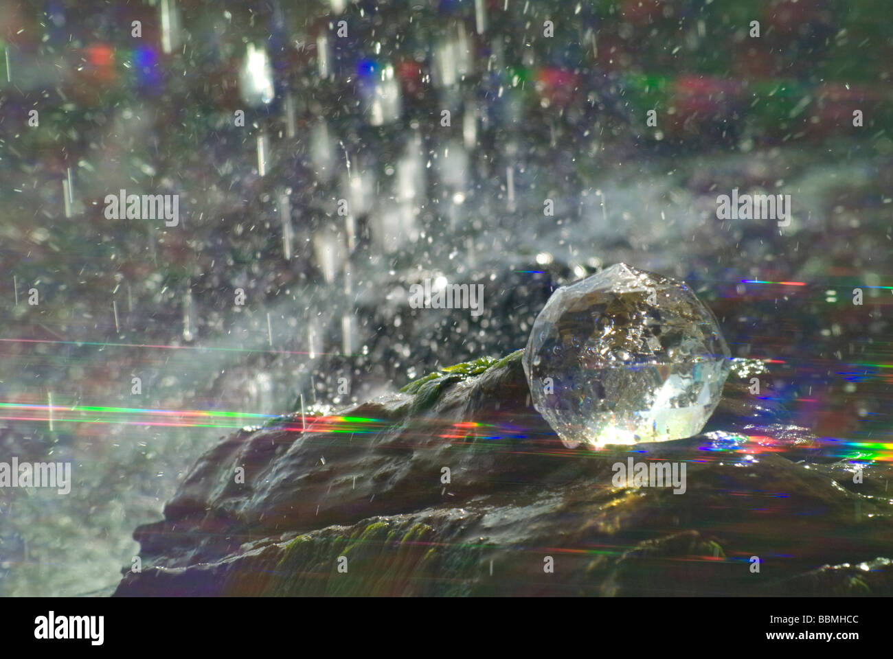 Glass crystal in waterfall with coloured light rays Stock Photo - Alamy