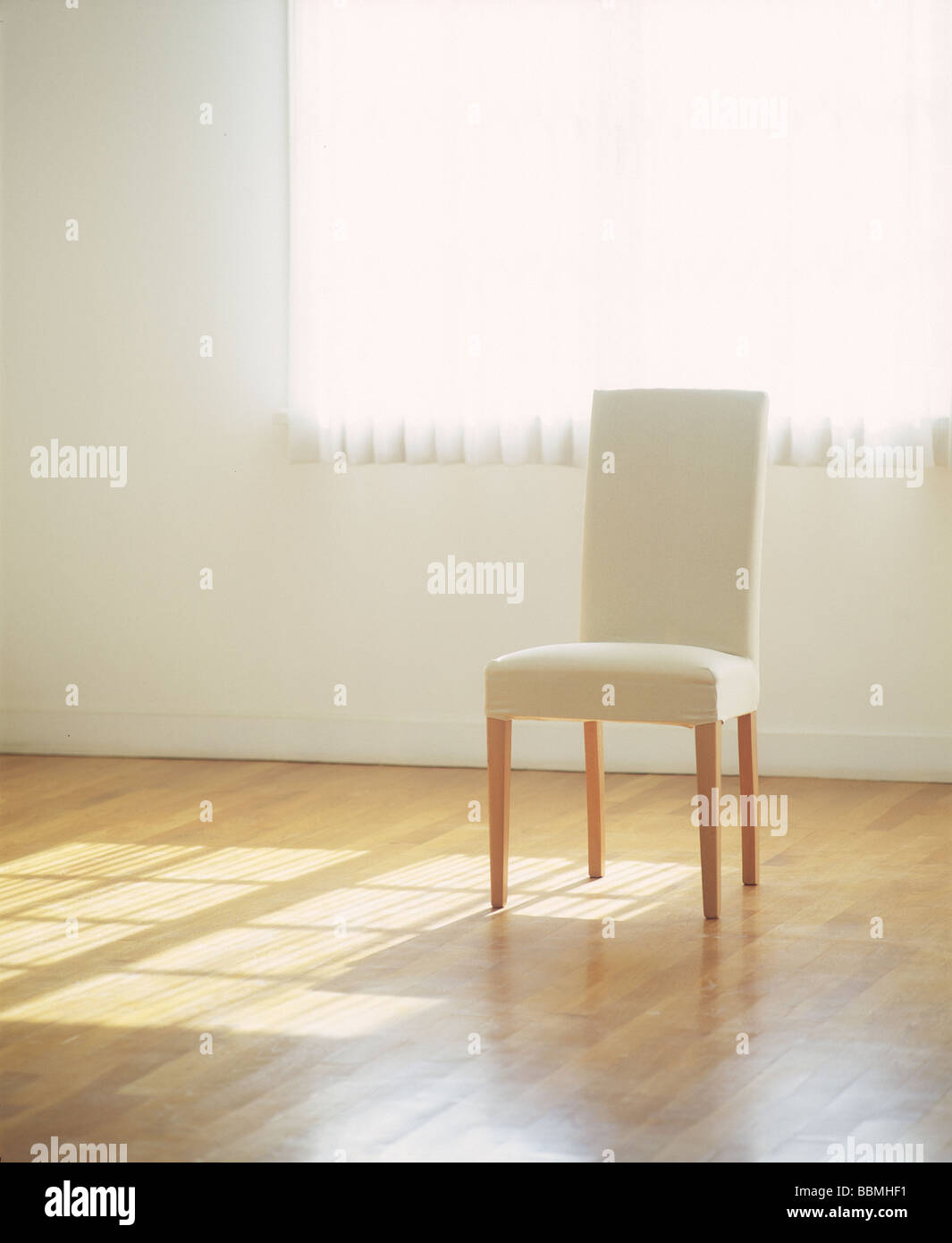 Chair beside window in living room Stock Photo - Alamy