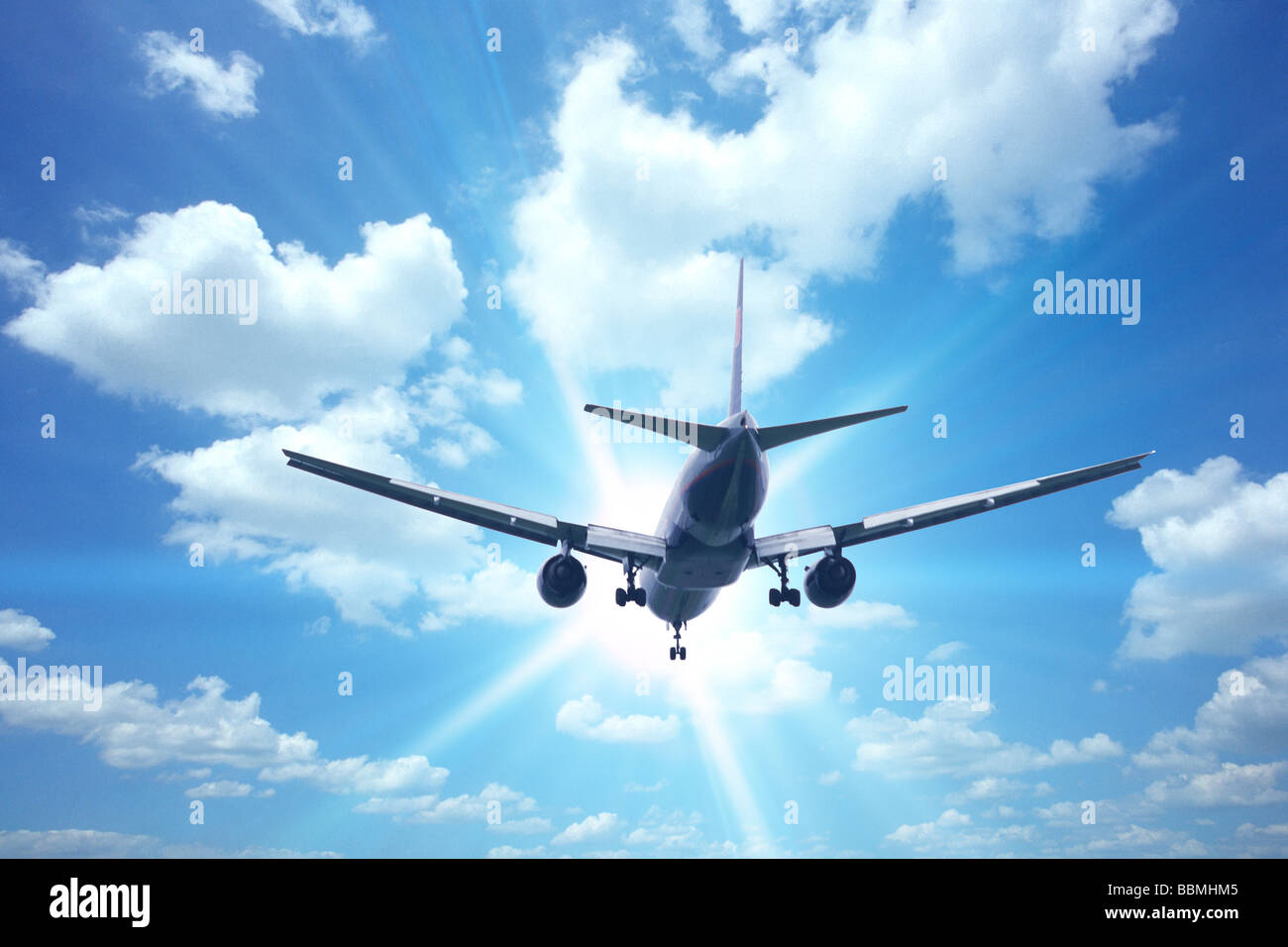 Airplane against sun, low angle view Stock Photo - Alamy
