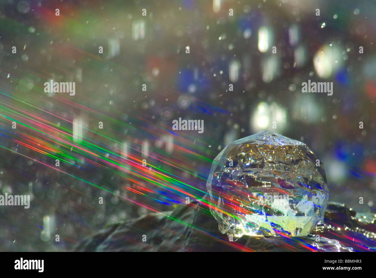 Glass crystal in waterfall with coloured light rays Stock Photo - Alamy