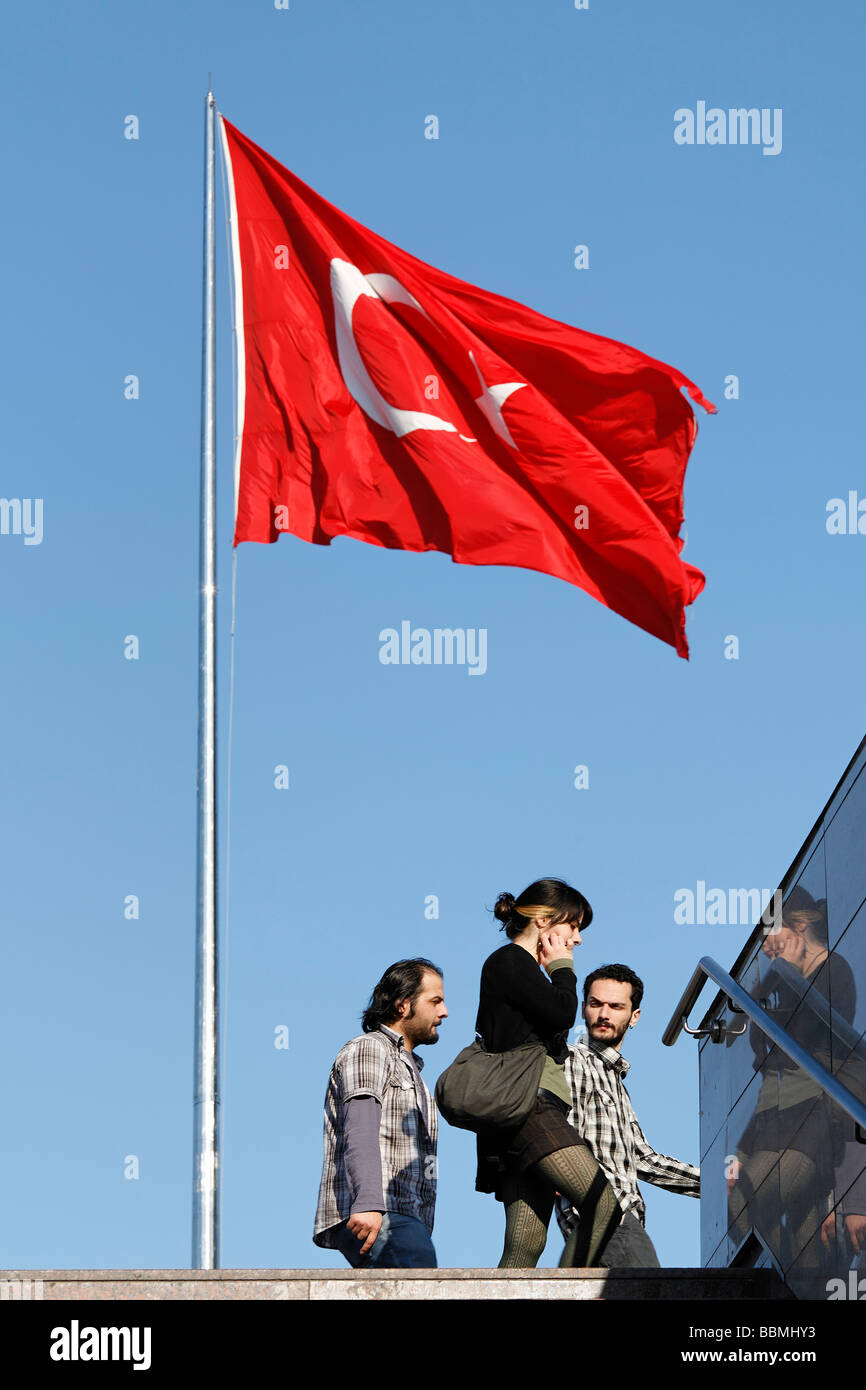 Young people in European dress walking under the Turkish flag, Taksim ...