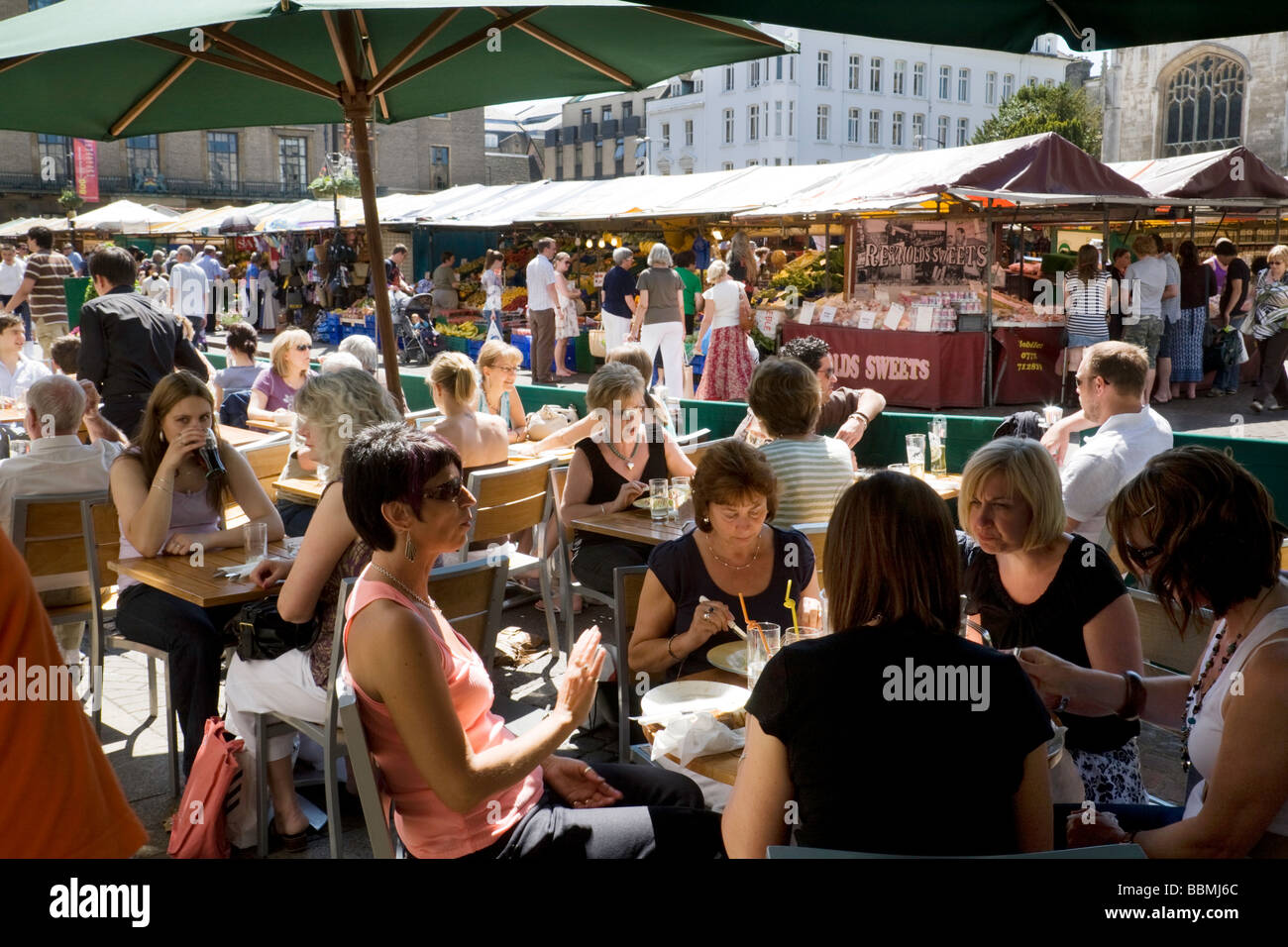People eating at an outside restaurant in the market square, Cambridge ...