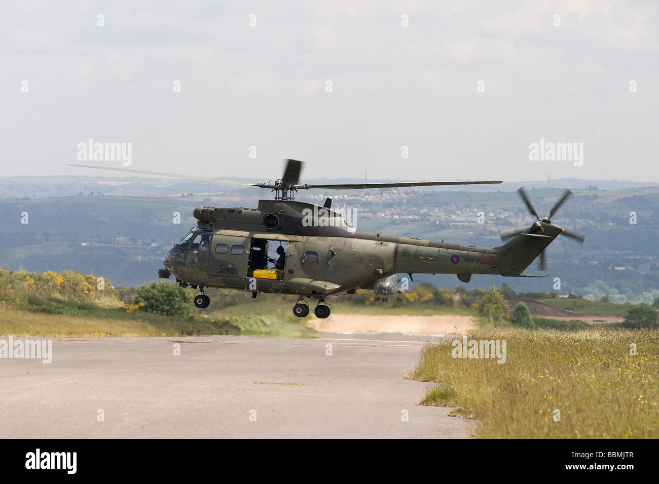 An RAF puma helicopter over Huddersfield at Crosland Moor Stock Photo ...