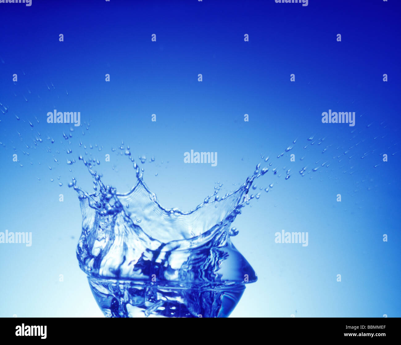 Water splashing out of glass bowl Stock Photo - Alamy