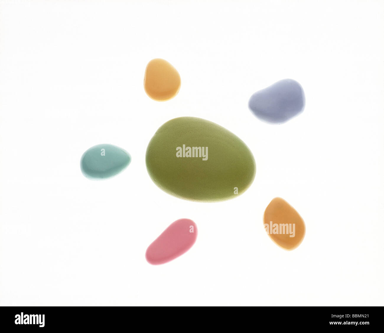 Multi colored pebbles on white background, high angle view, close-up ...