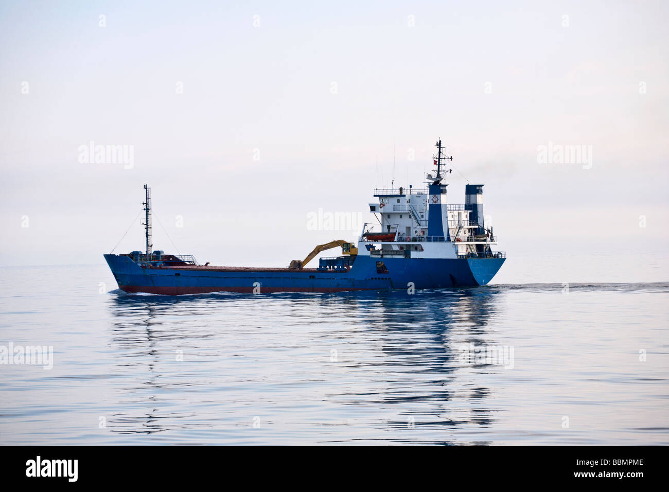 Ship with a excavator on deck Stock Photo - Alamy
