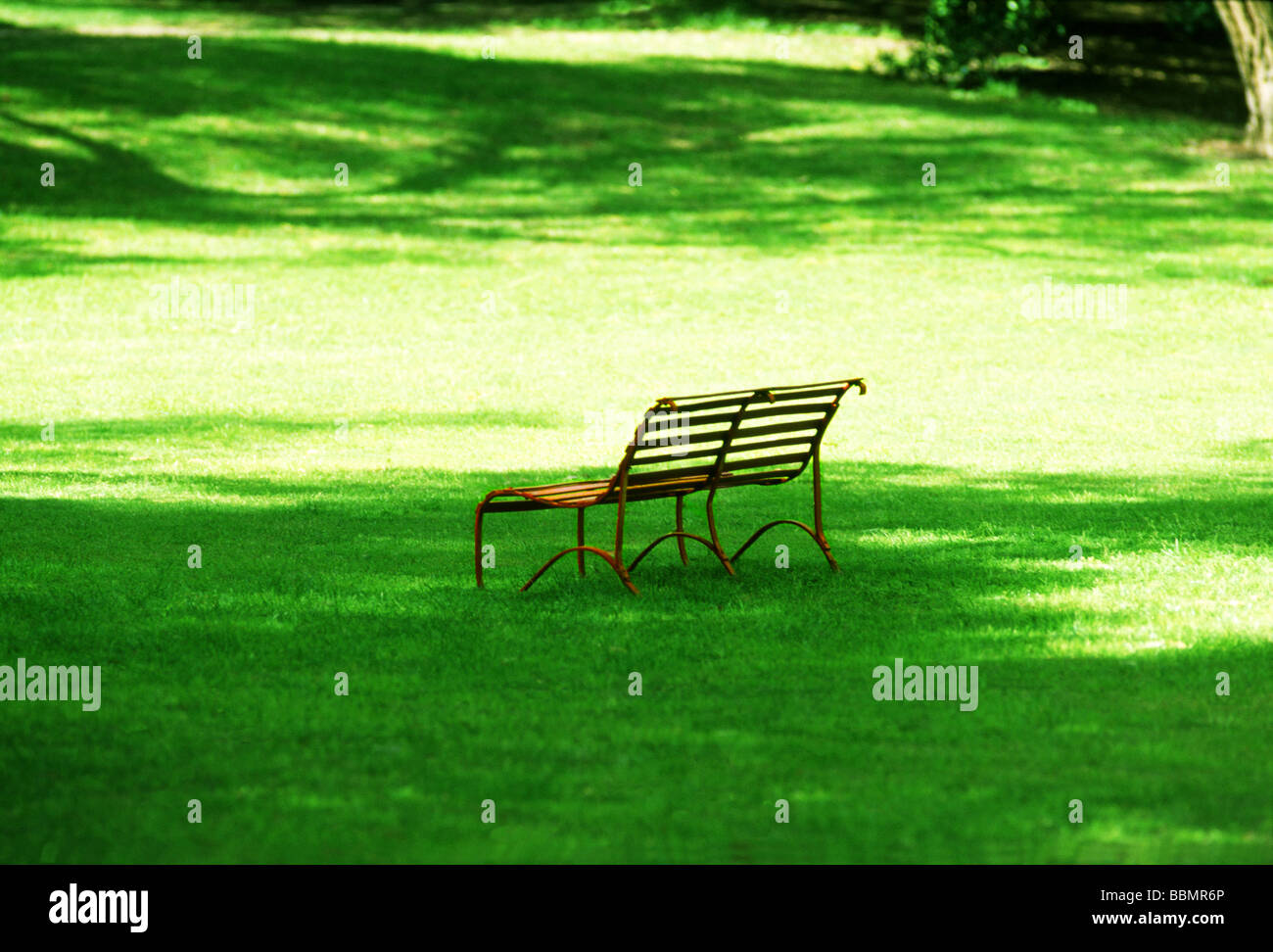 A park bench on a green land Stock Photo - Alamy