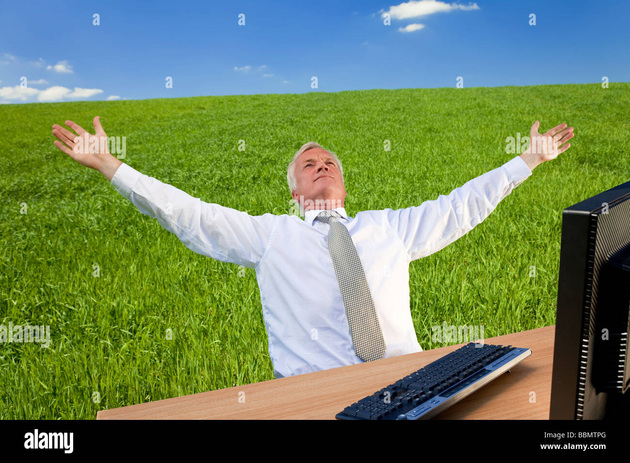 Concept shot showing an older male executive using a computer in a ...