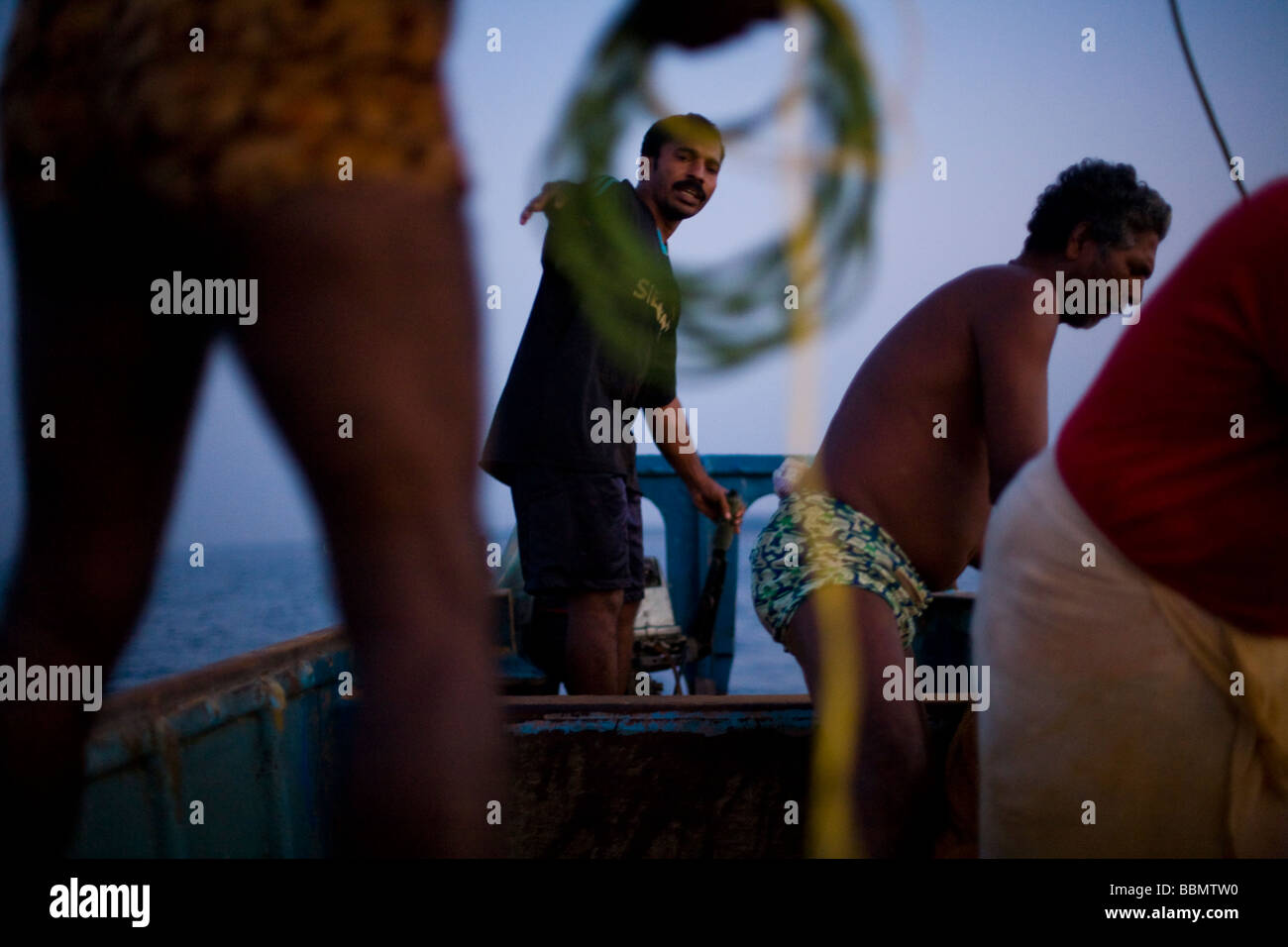 Fishing boat captain directs his crew in open boat Stock Photo - Alamy