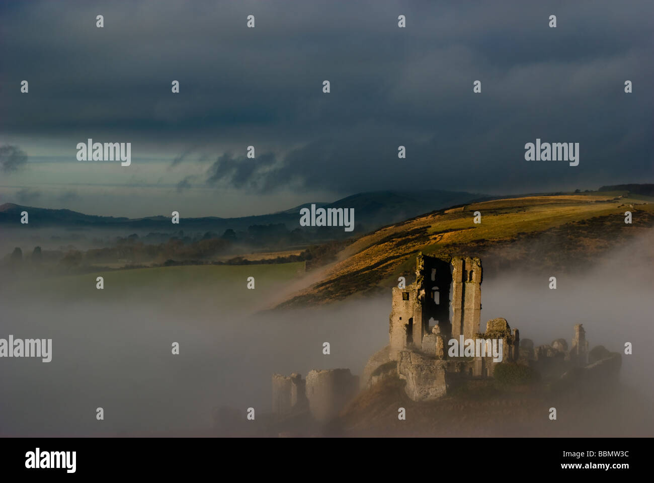 Corfe Castle Dorset in the early morning mist at sunrise Stock Photo ...