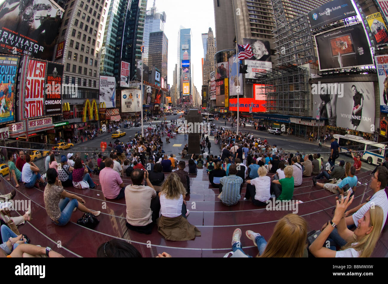 People relax on the red stairs behind the TKTS booth at Times Square in ...