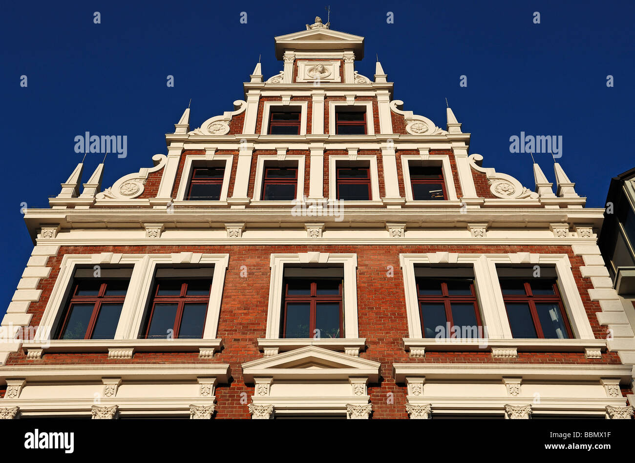 Old decorative house front of a community house against a blue sky ...