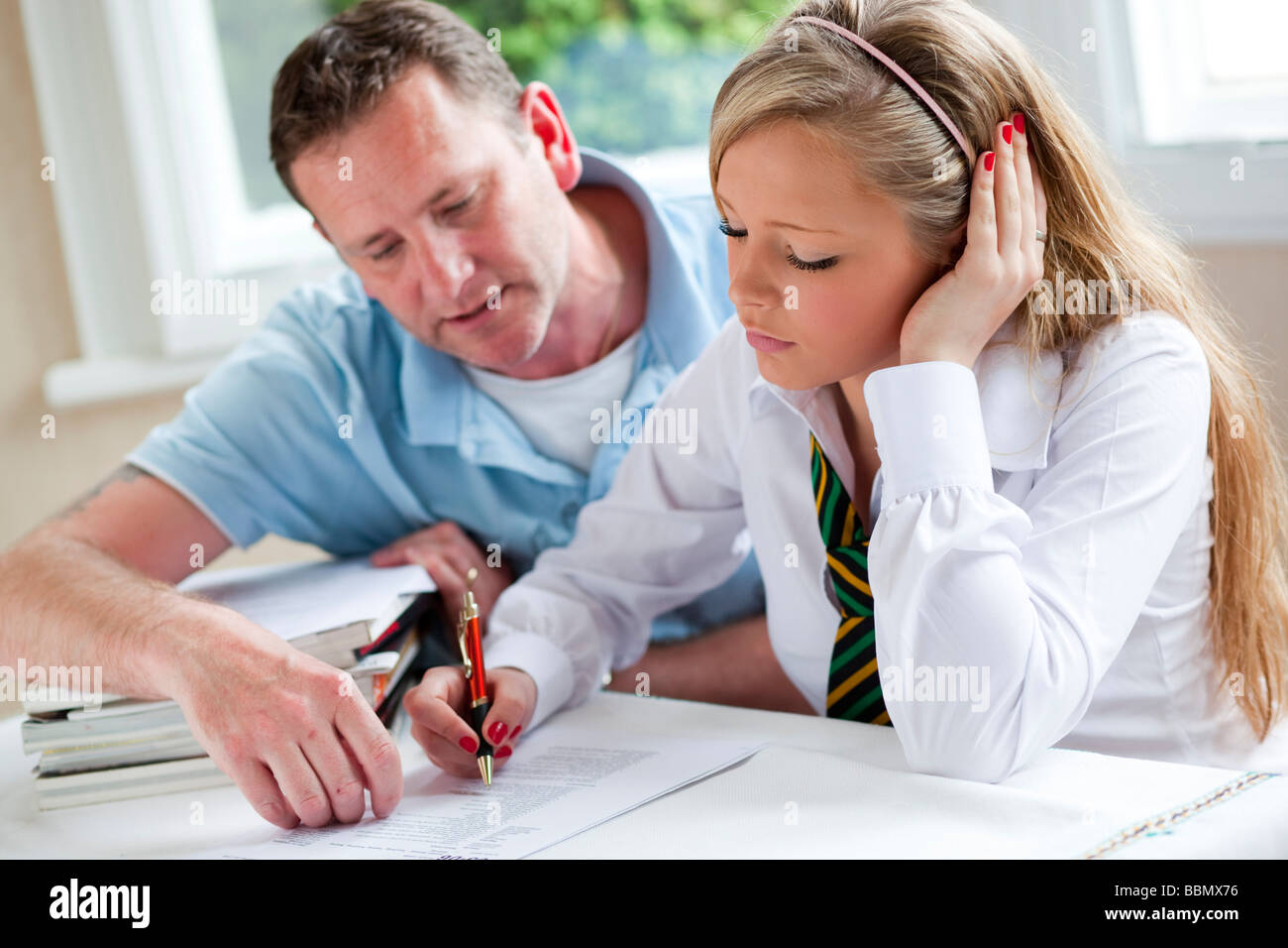 Father helping daughter with homework Stock Photo - Alamy