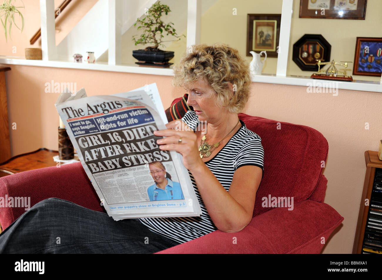 Middle aged woman reading regional local newspaper Stock Photo - Alamy