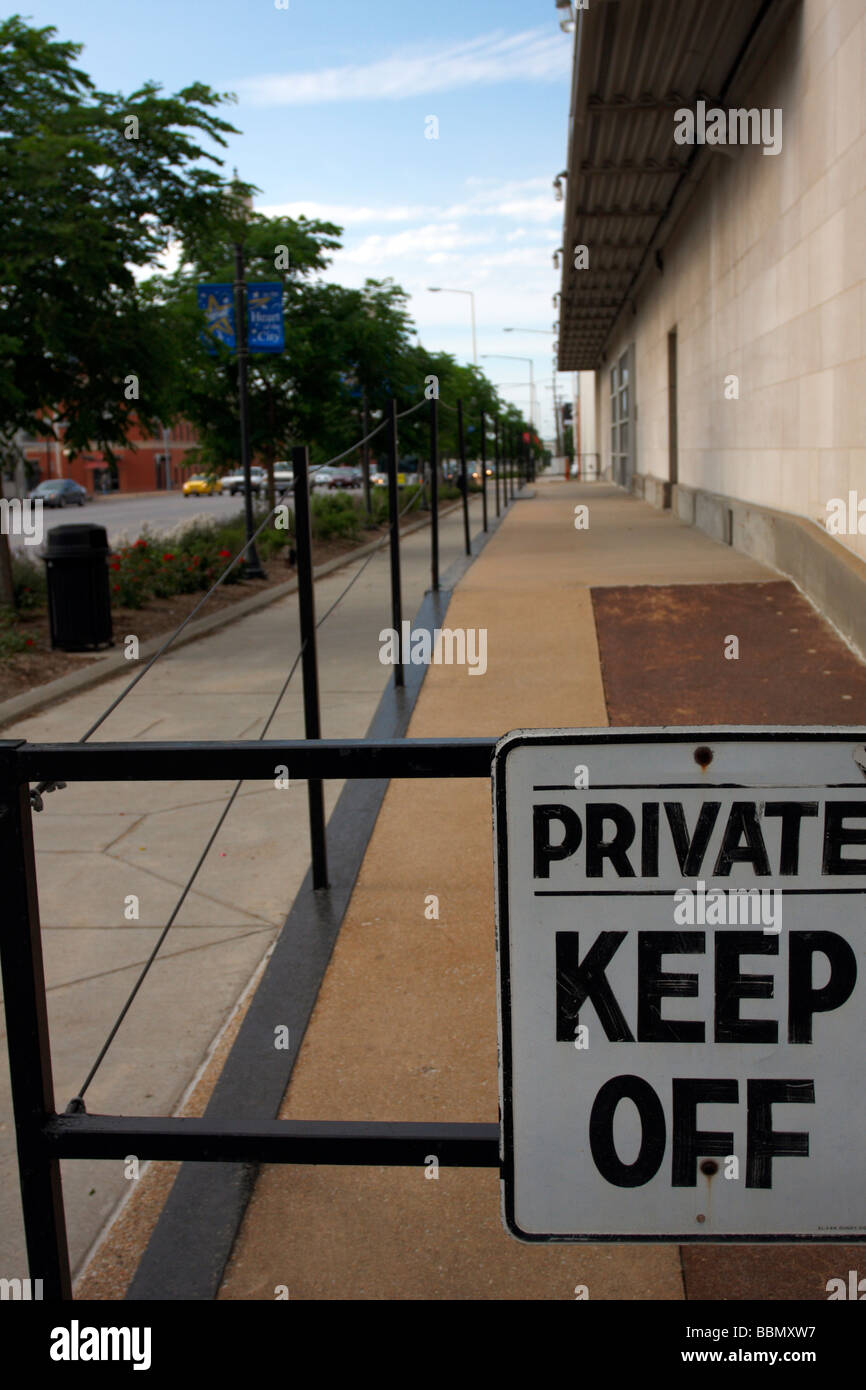 Private, Keep Off sign next to loading dock and sidewalk, city street ...