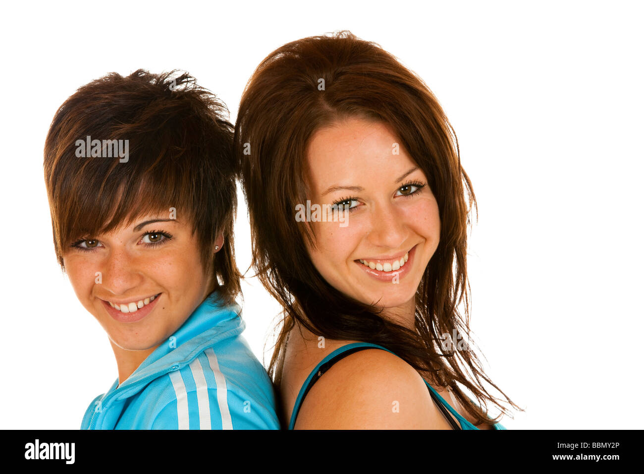 Two young women, back to back Stock Photo - Alamy