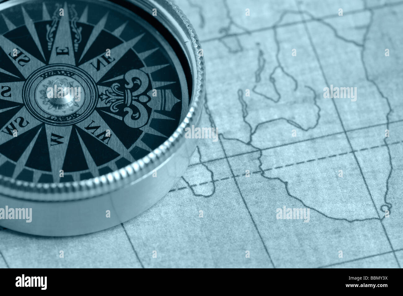 Old compass and map background blue color Stock Photo - Alamy