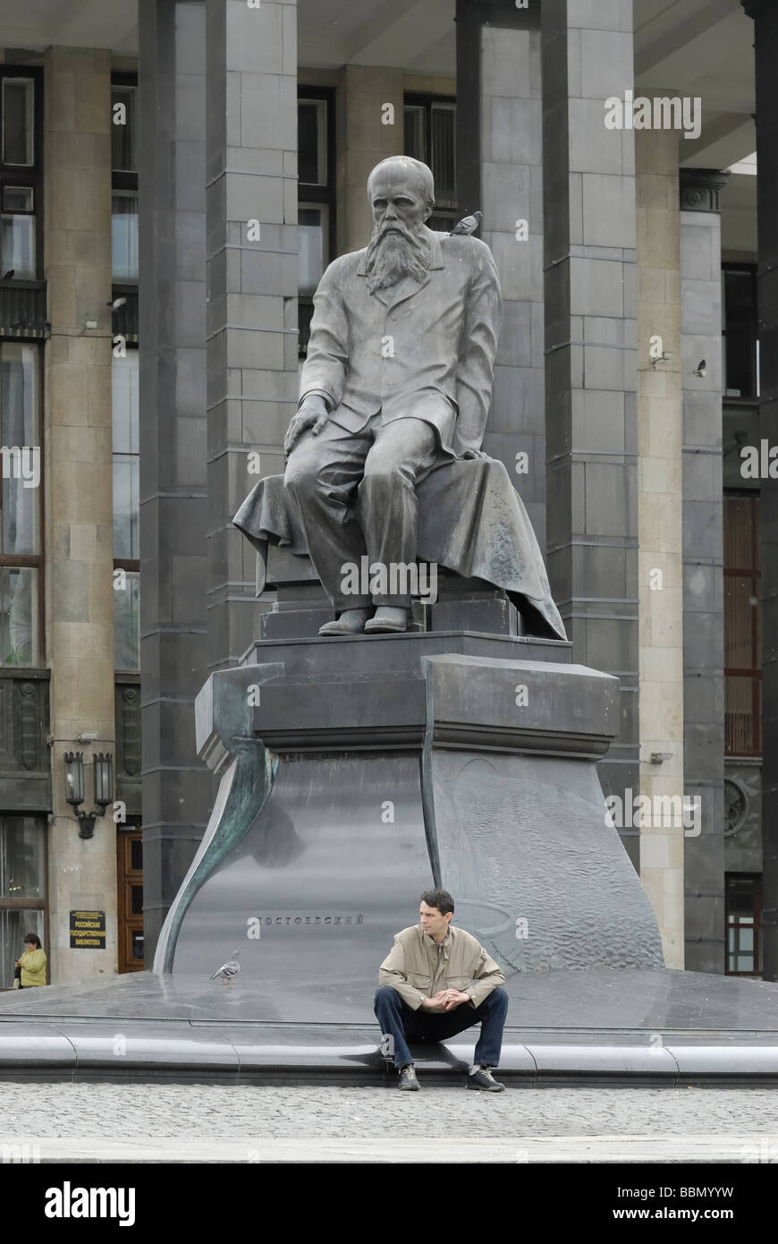 Man sits next the statue of Russian writer Fiodor Dostoevski Stock ...