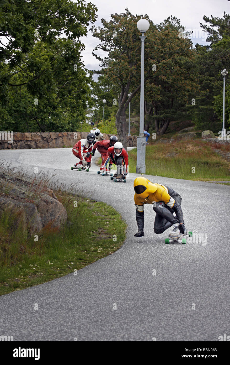 Skateboarders speed down the winding road Stock Photo - Alamy