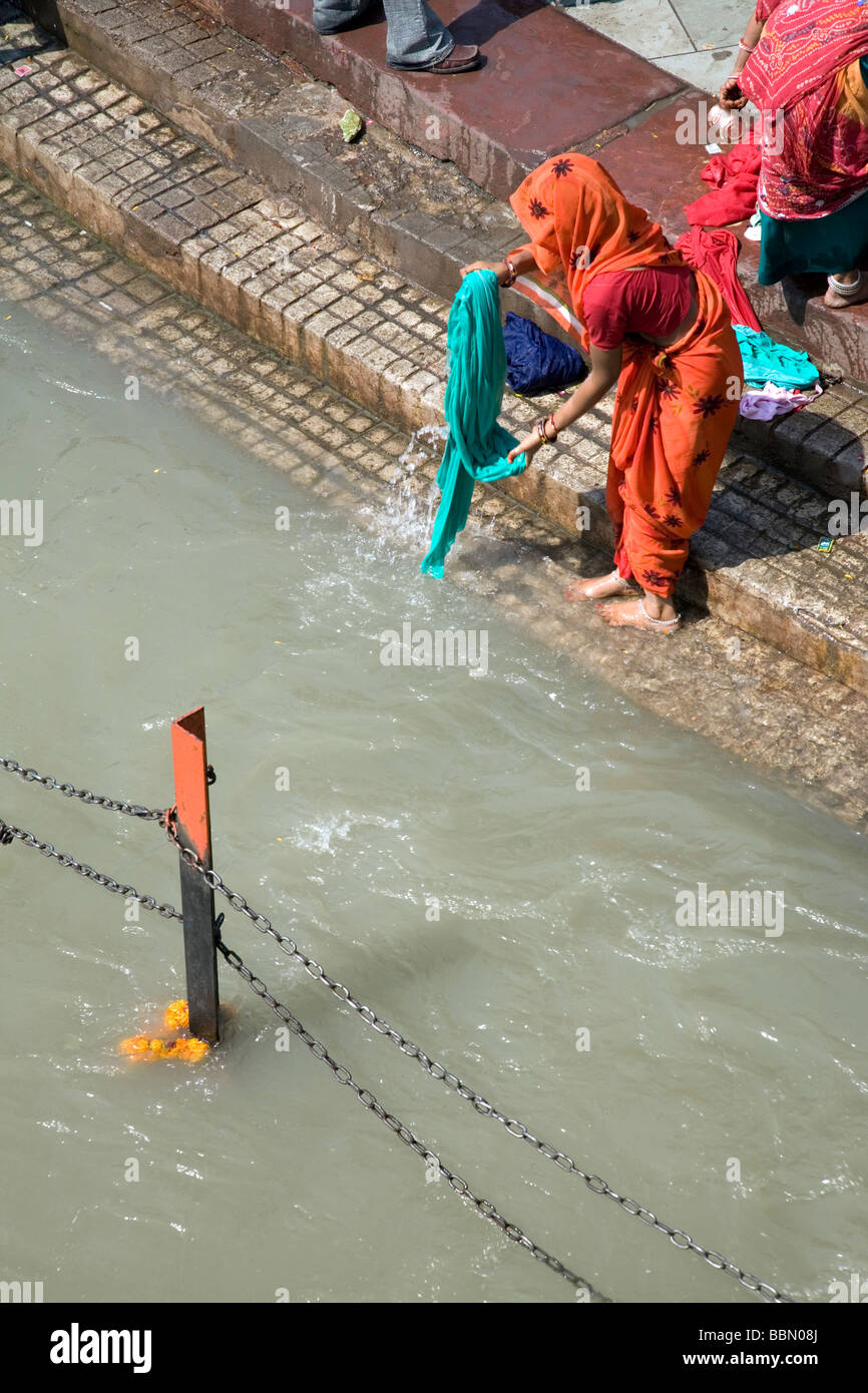 Indian woman washing a sari. Ganges river. Haridwar. India Stock Photo ...