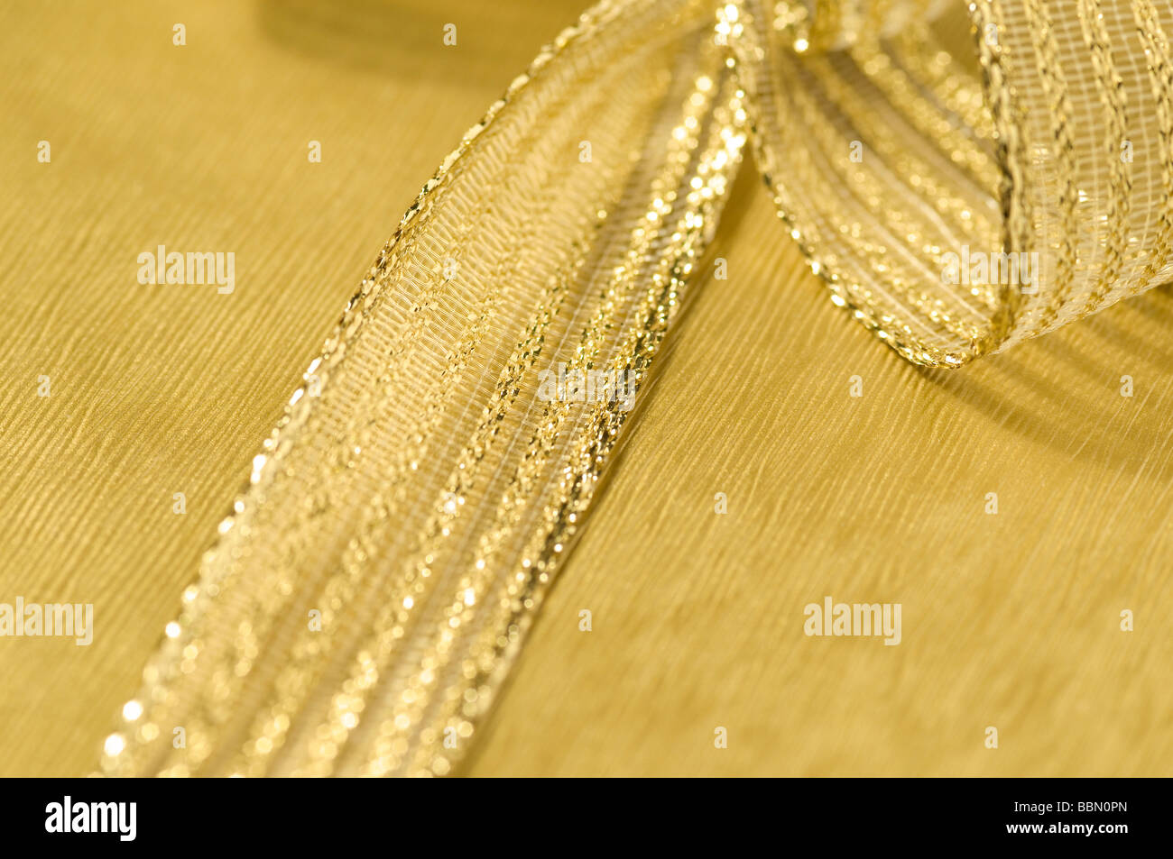 gold ribbon bow on top of chocolate box Stock Photo - Alamy