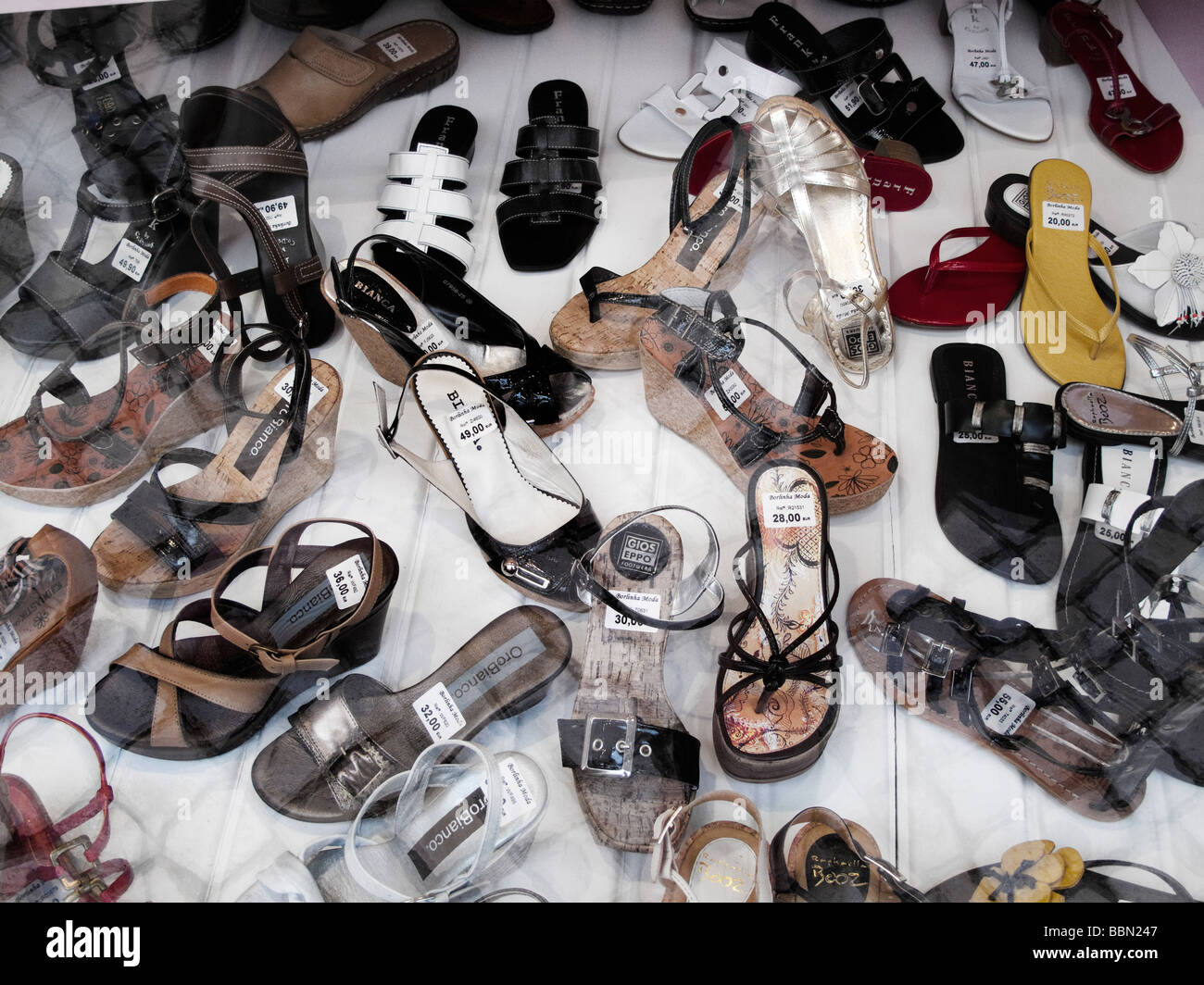 Womans sandals on display in shop window Stock Photo - Alamy