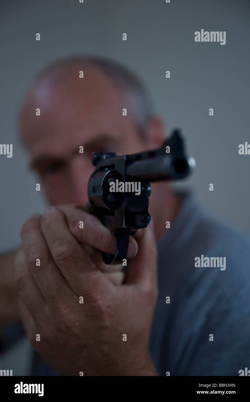 A man aiming with a revolver Stock Photo - Alamy