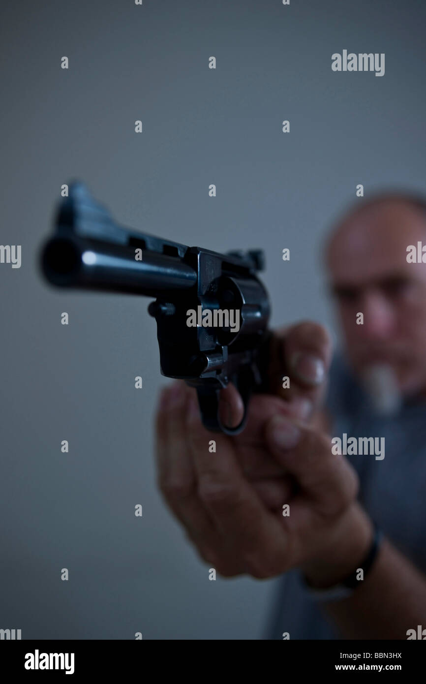 A man aiming with a revolver Stock Photo - Alamy