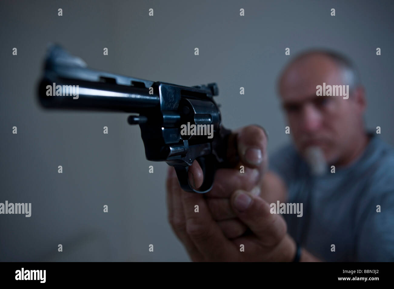 A man aiming with a revolver Stock Photo - Alamy