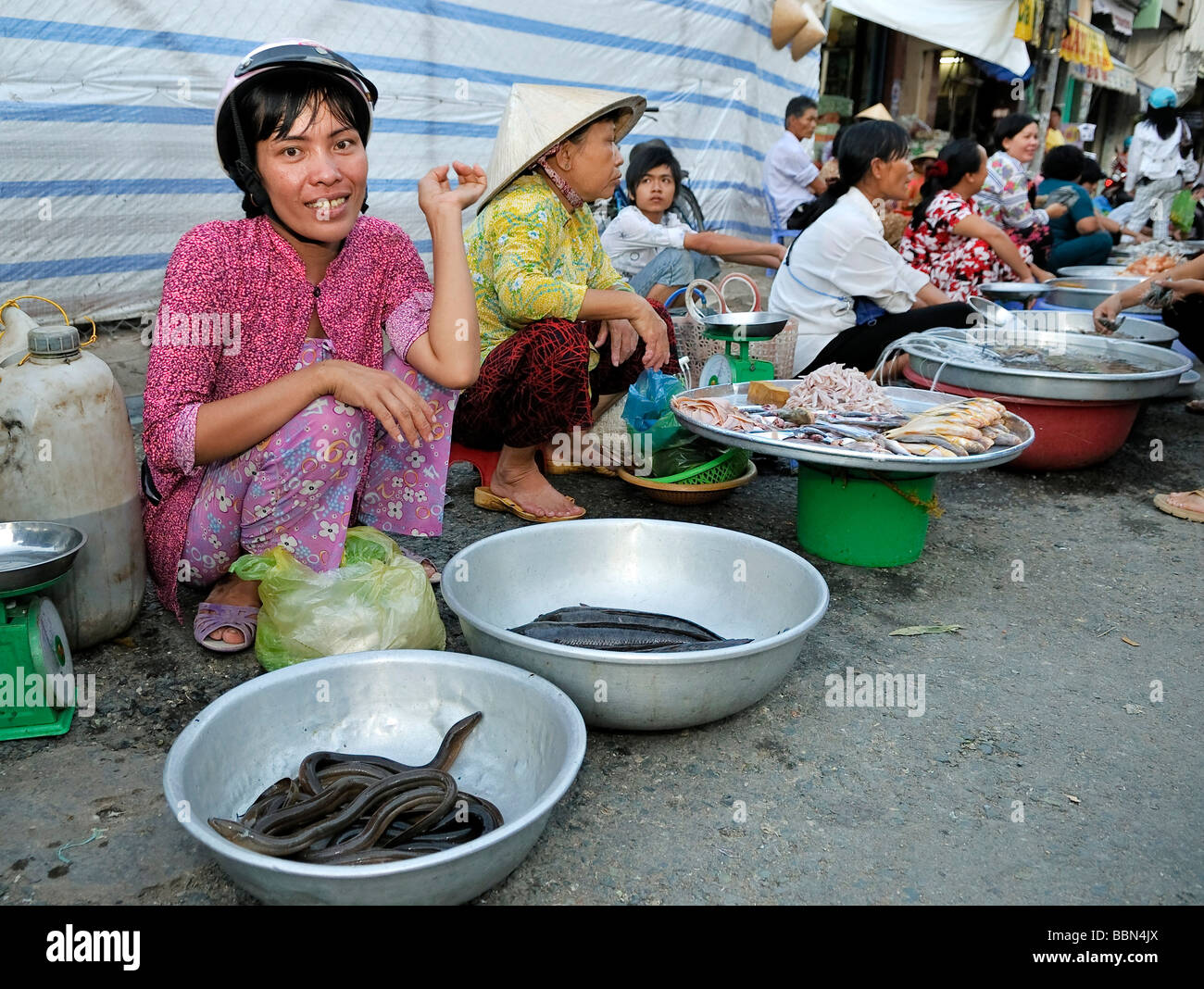 Women selling their goods, live eels, squid, dried fish, fish market ...