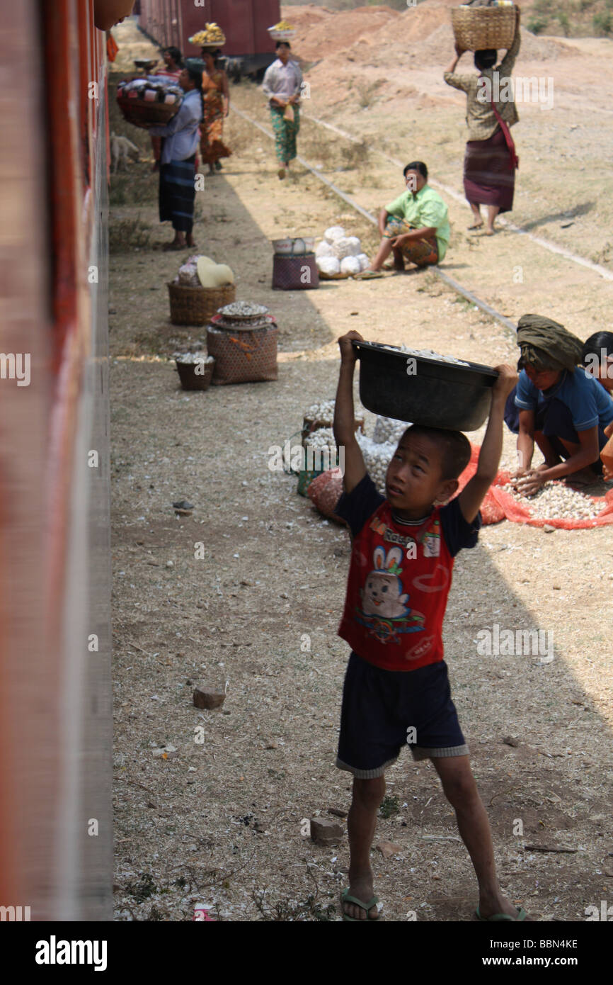 Young Burmese boy selling eggs by the side of a train, Kalaw, Myanmar ...