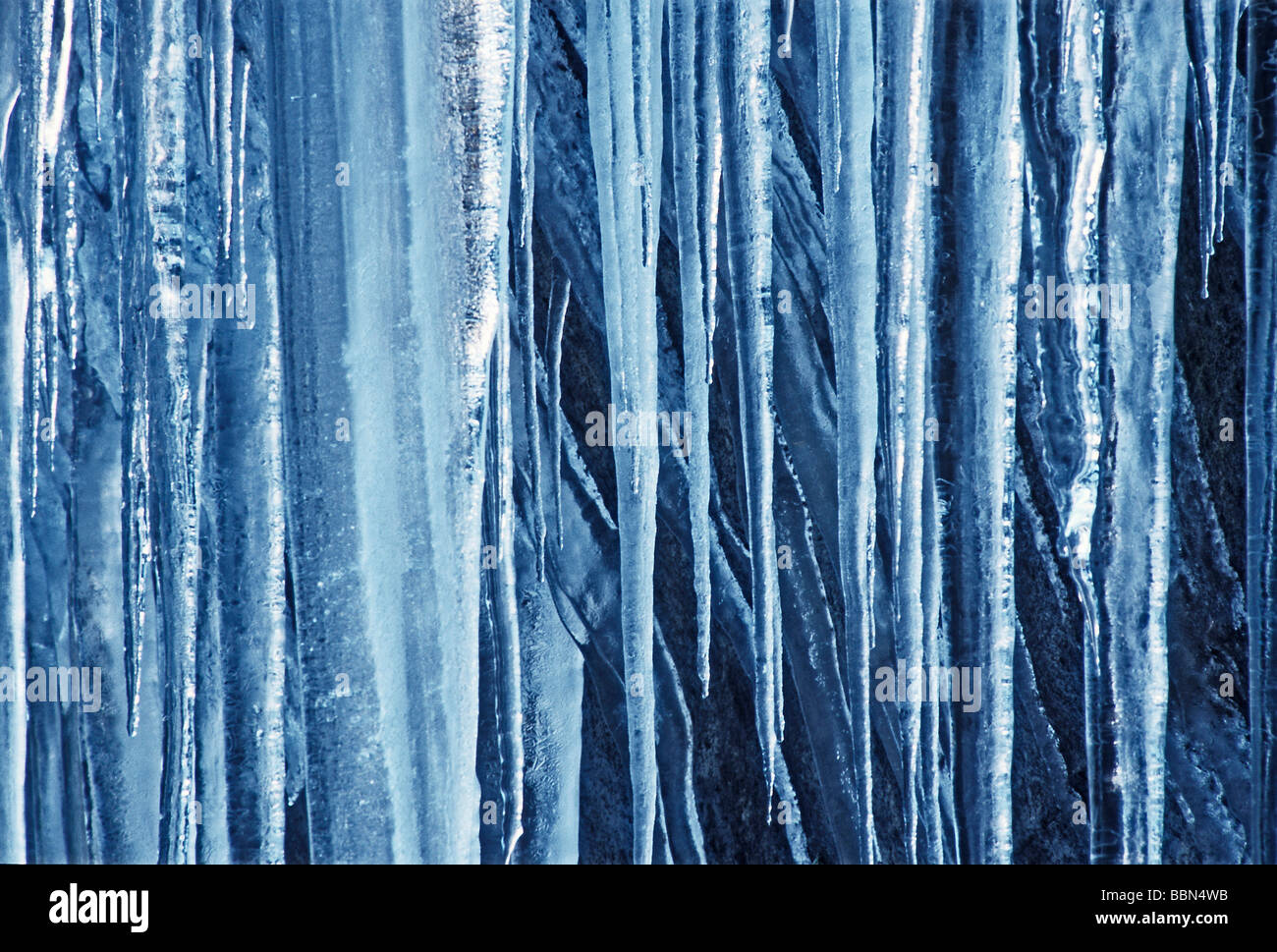 Blue icicles on a cliff Stock Photo - Alamy