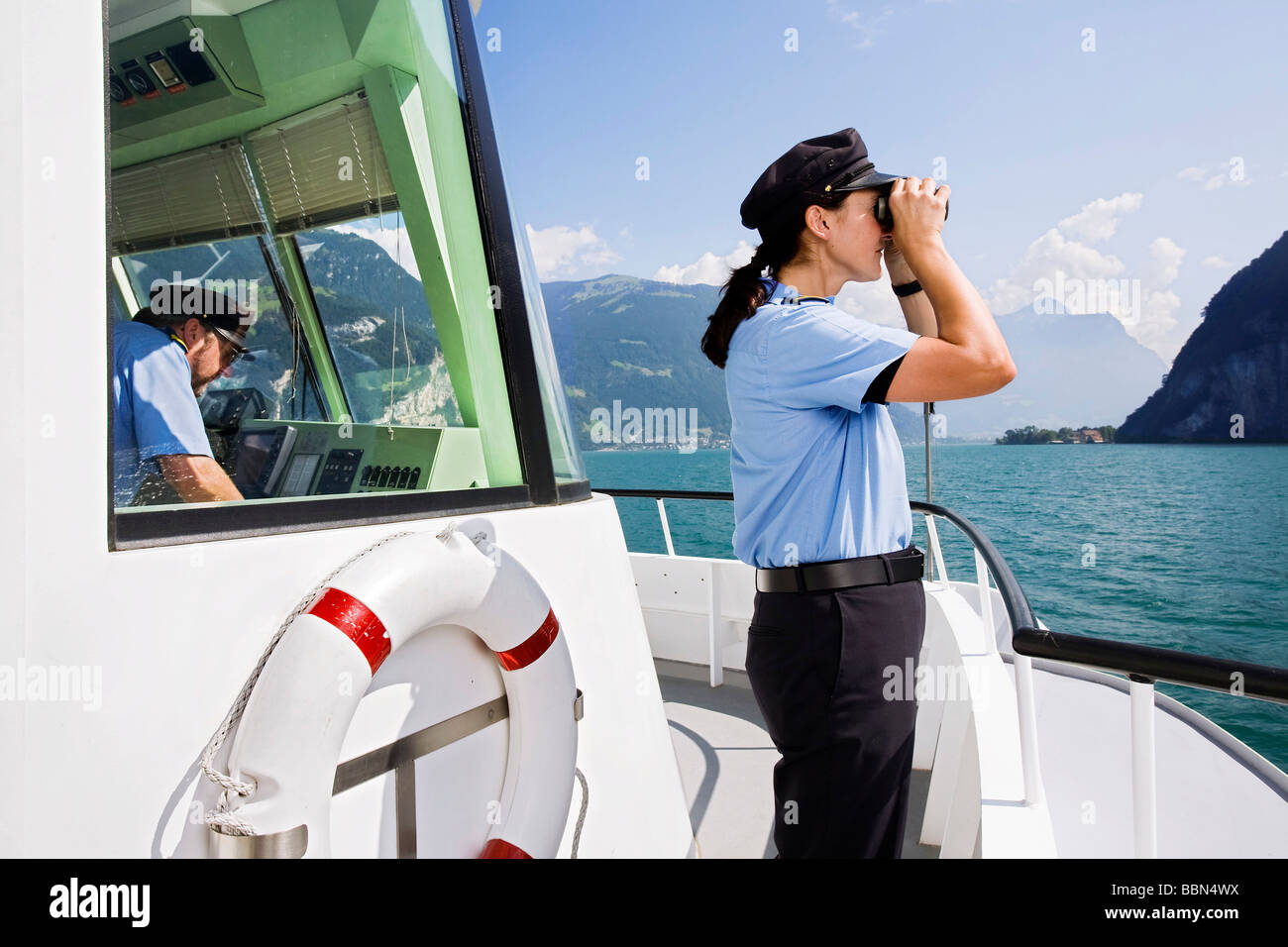 Ship's captain of a passenger motor vessel using binoculars on Lake ...
