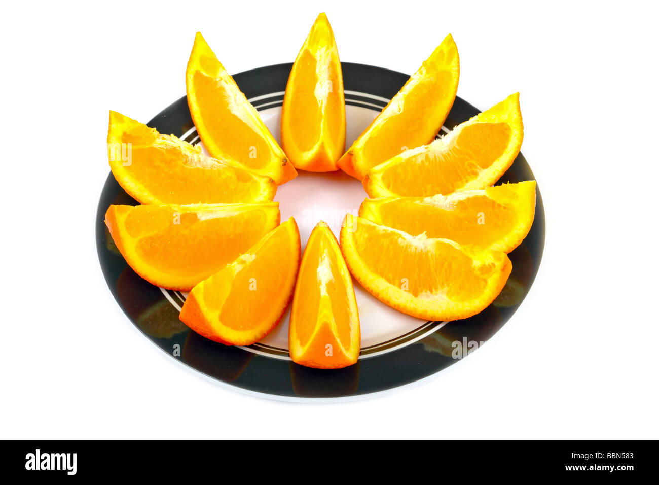 Orange segmented and arranged on a plate with white background Stock ...