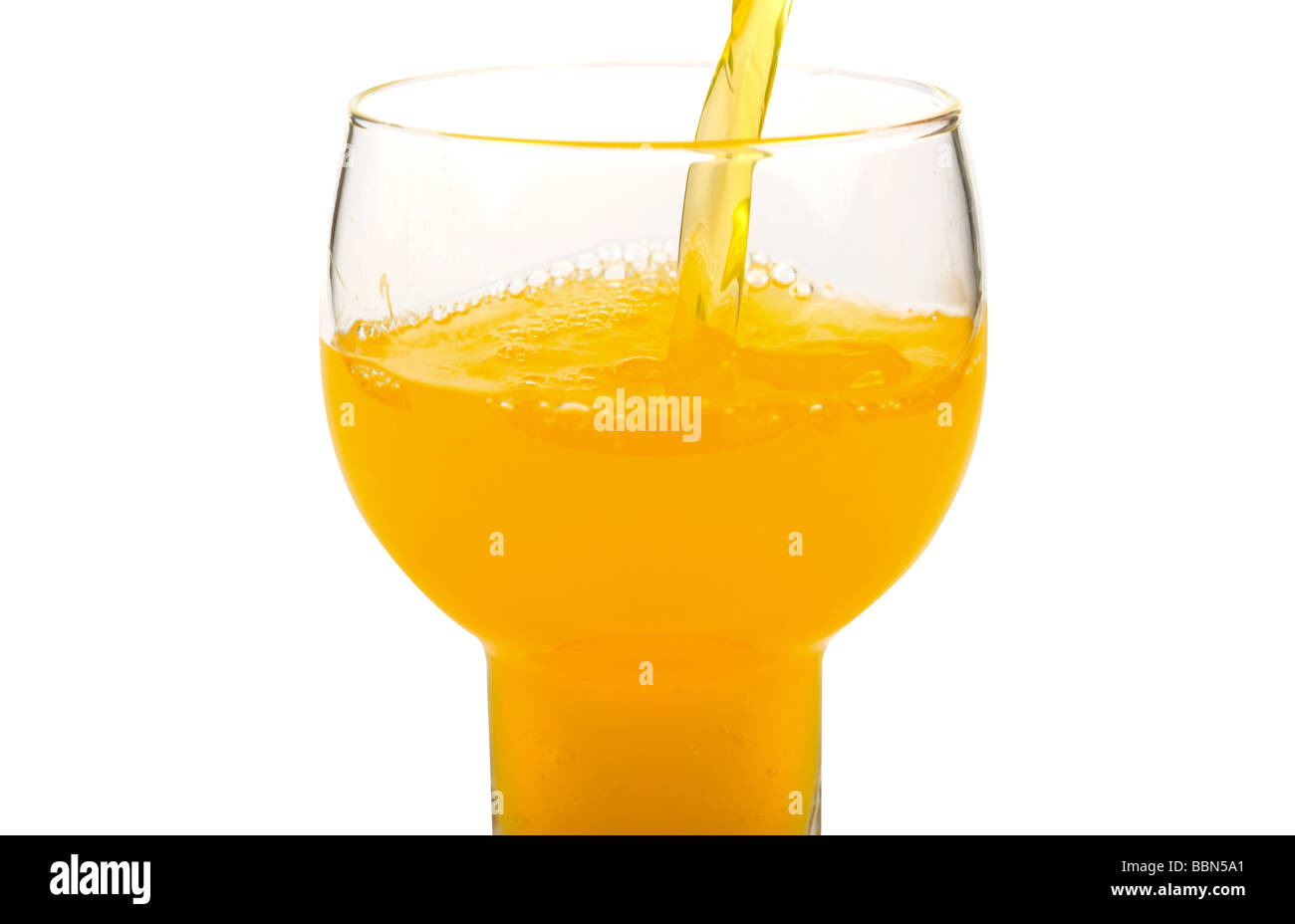 Juice pouring into glass closeup on the motion Stock Photo - Alamy