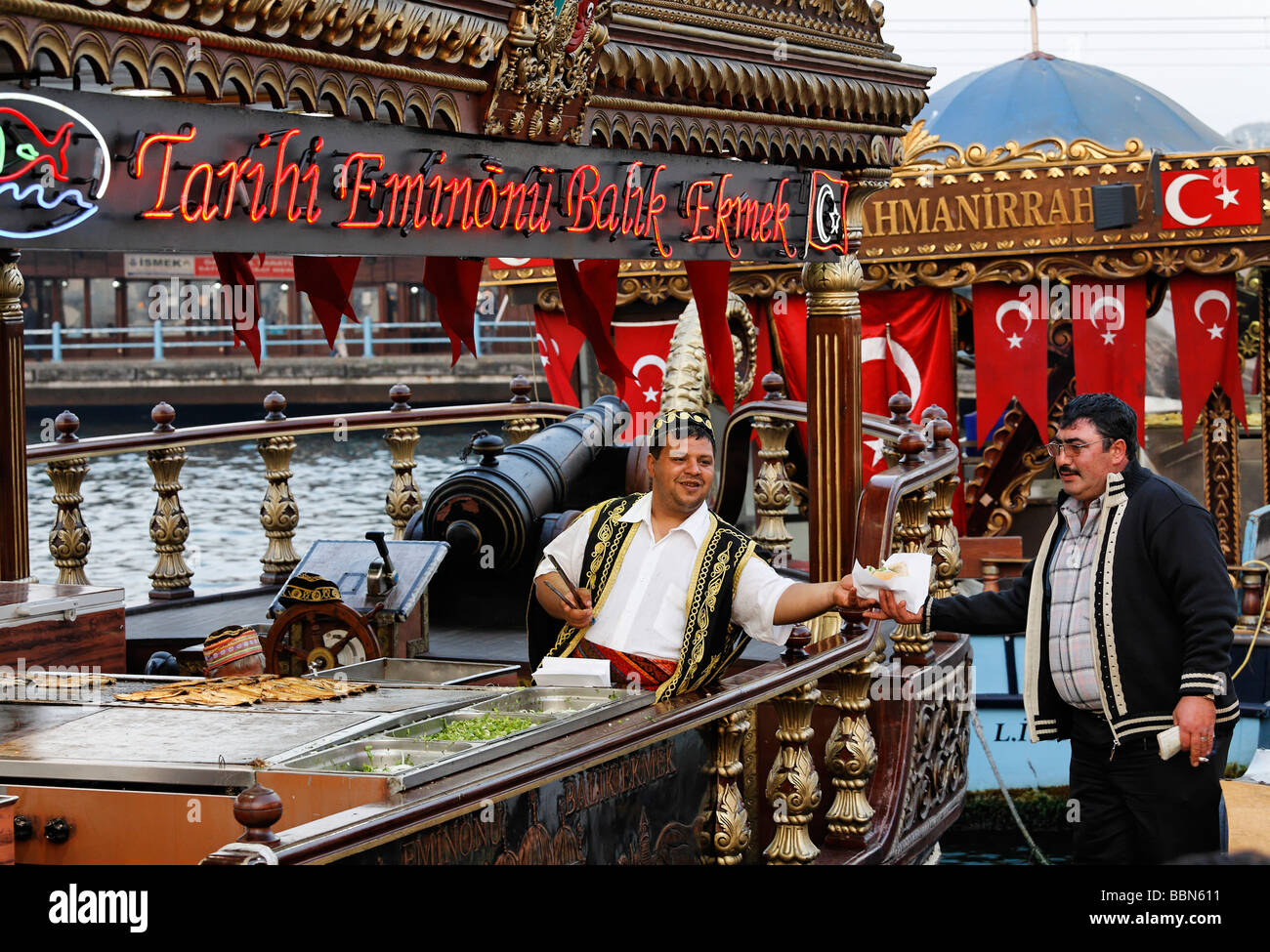 Fish cook in traditional costume on a historically decorated boat, fish ...
