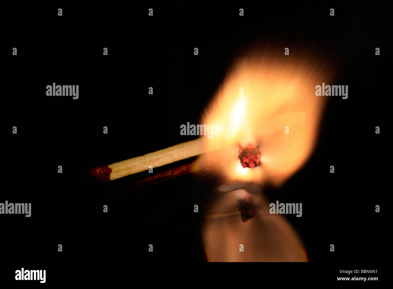 A match stick on fire, on a black reflective surface Stock Photo - Alamy
