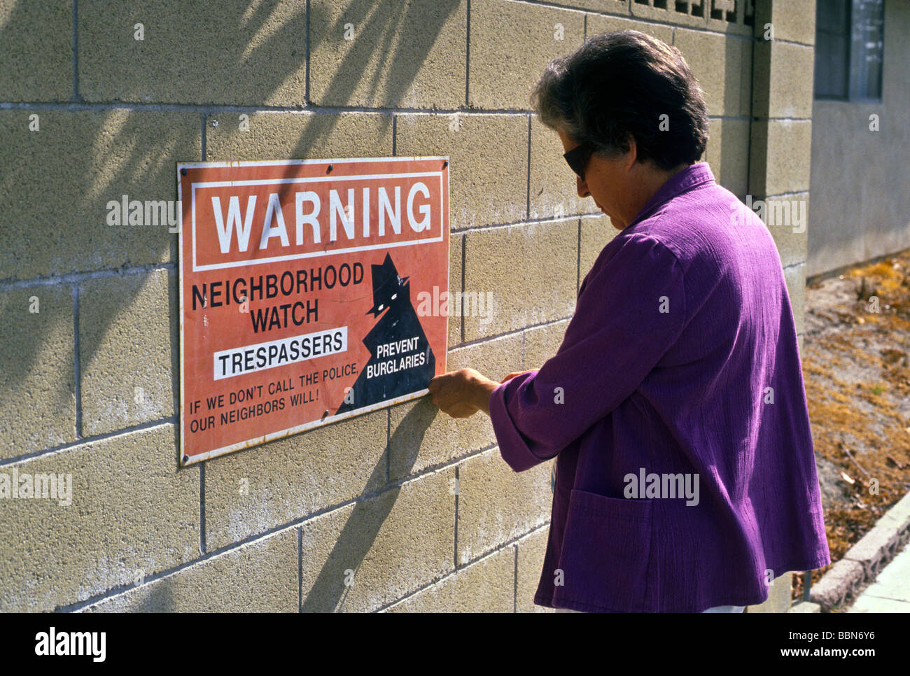 neighborhood watch woman install sign safe law protection security ...