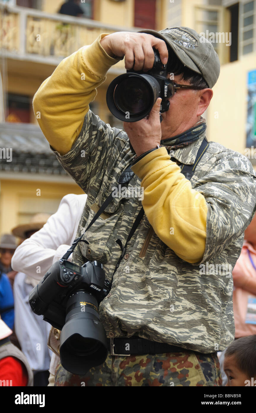 Chinese photographer and his Nikon cameras Stock Photo - Alamy