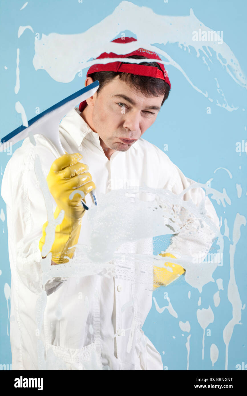 Man cleaning window with window washer, portrait Stock Photo - Alamy