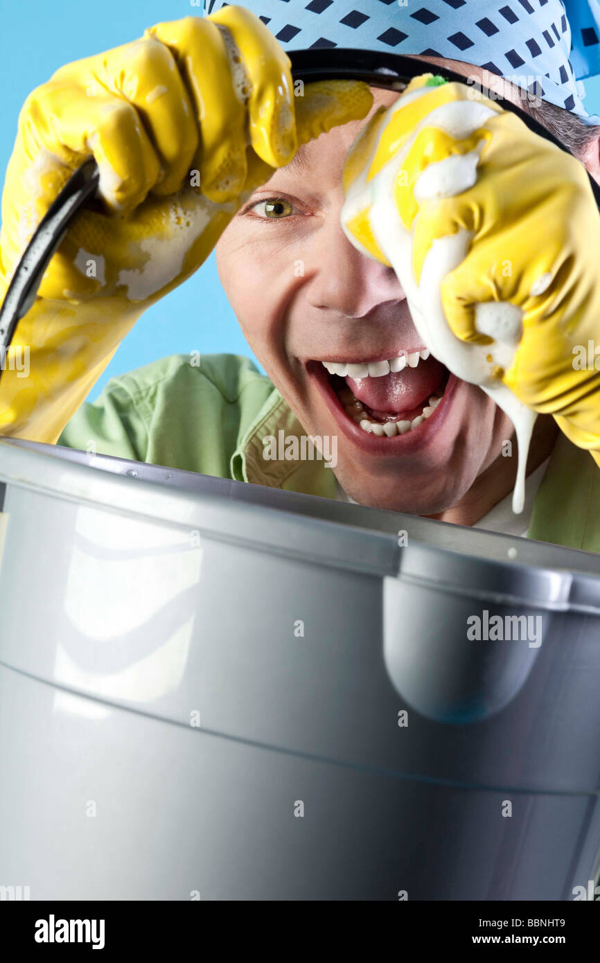 Man holding bucket, laughing, portrait Stock Photo - Alamy